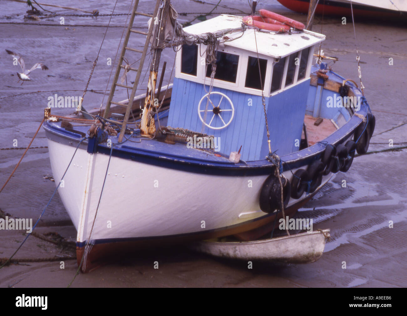 Dinghy crushed under fishing boat at Low tide Ilfracombe harbour Devon ...