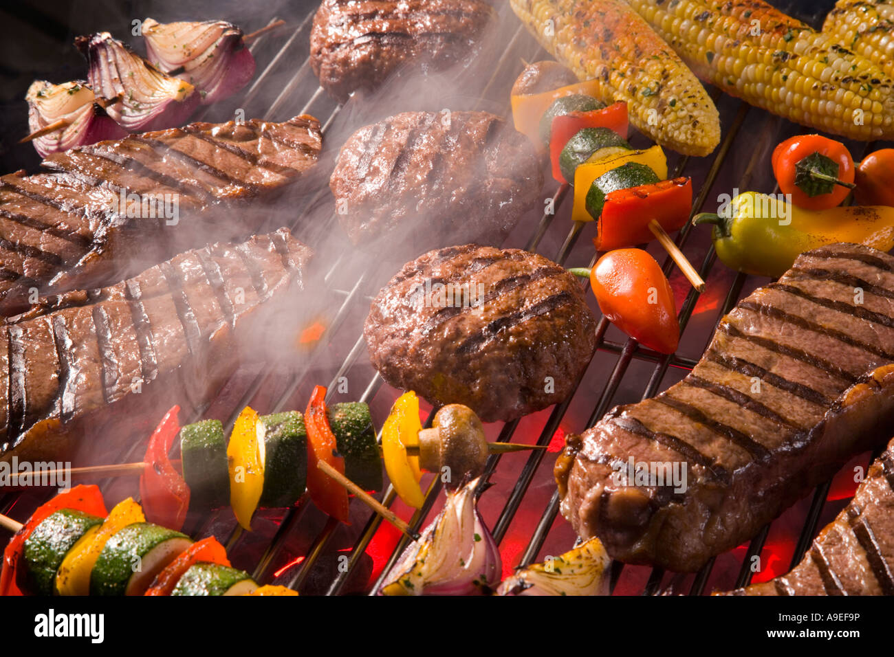 Steaks, burgers and veggies get ready to come off the grill Stock Photo ...