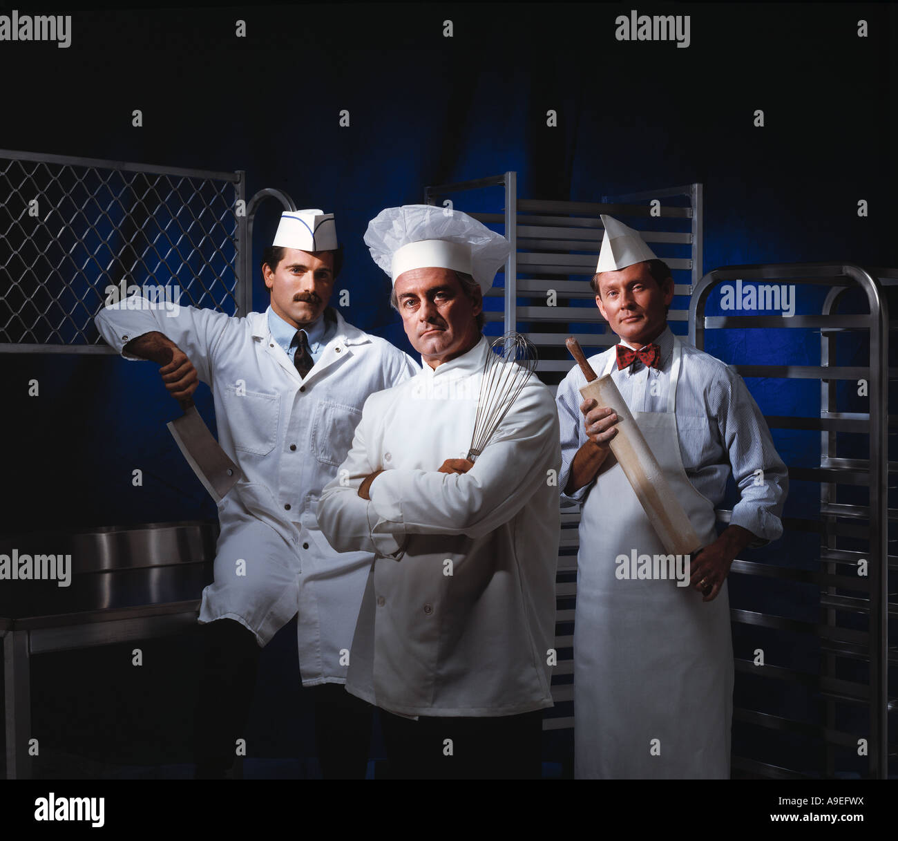 Three very serious chefs look at the camera Stock Photo - Alamy