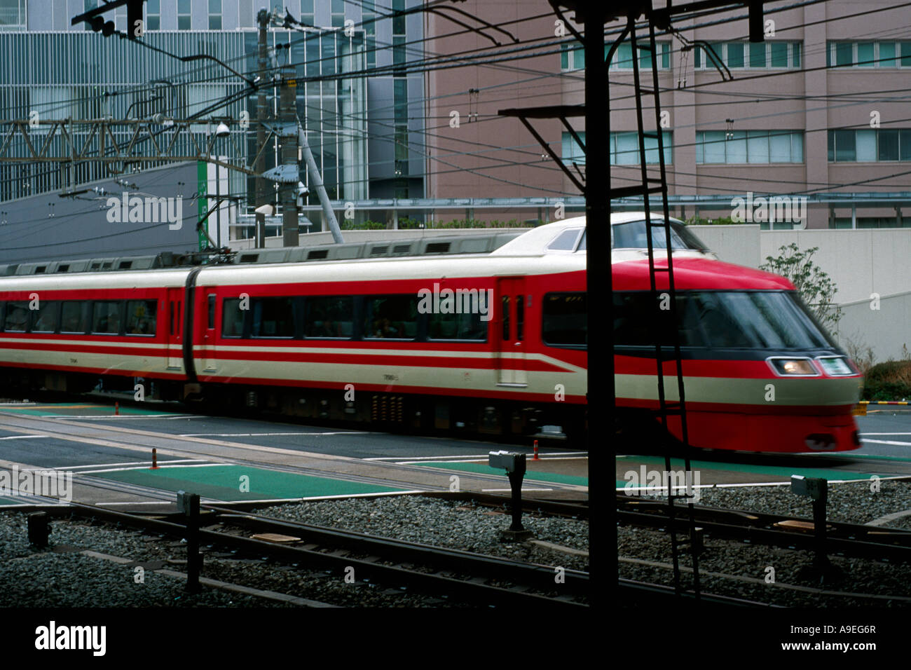 Commuter train passing through central Tokyo Stock Photo - Alamy