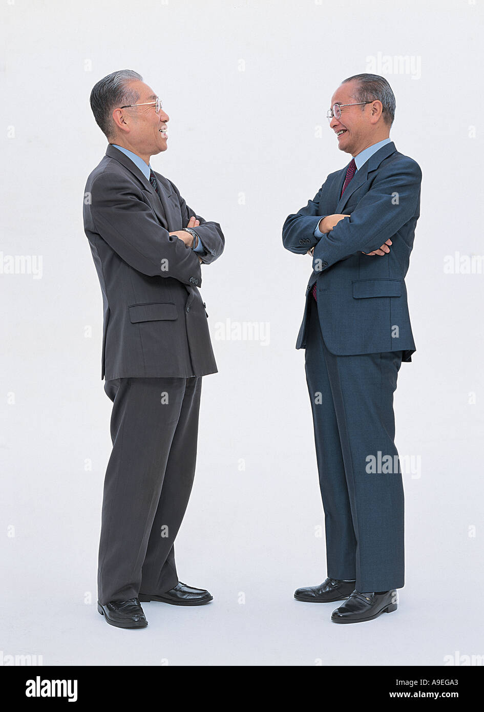 Businessmen folding their arms Stock Photo - Alamy