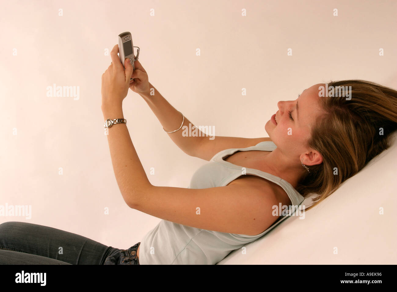 Mobile phone being used by young woman texting Stock Photo - Alamy