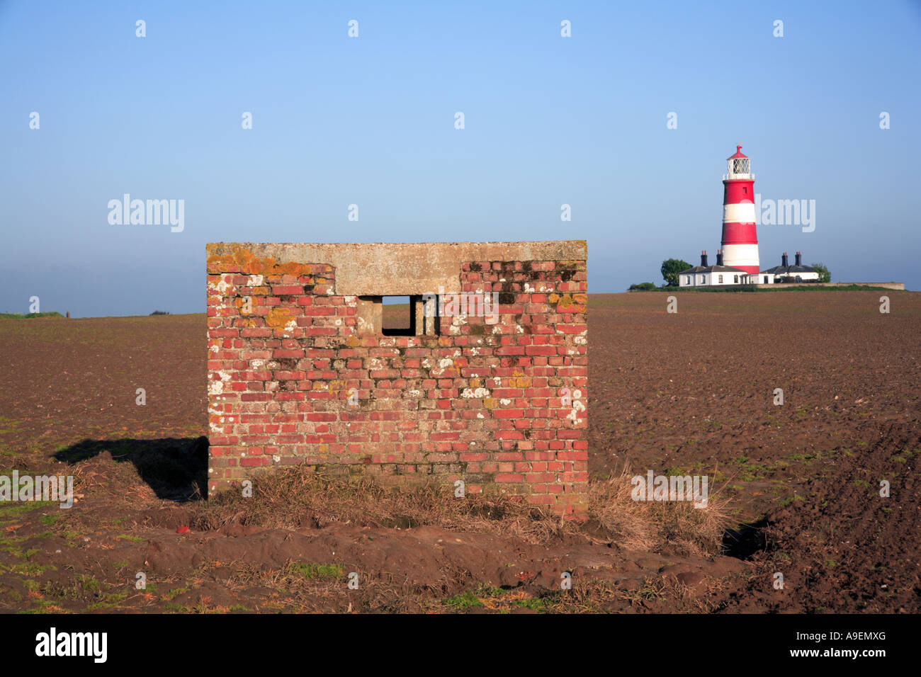 A Second World War pillbox with lighthouse in background on the North ...