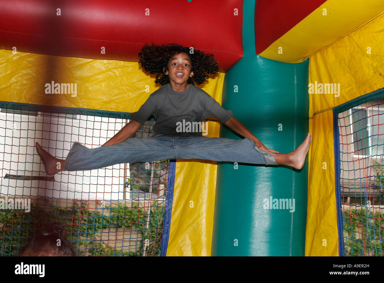 Ethnic Minority Boy doing the Splits in a Jumper Stock Photo - Alamy