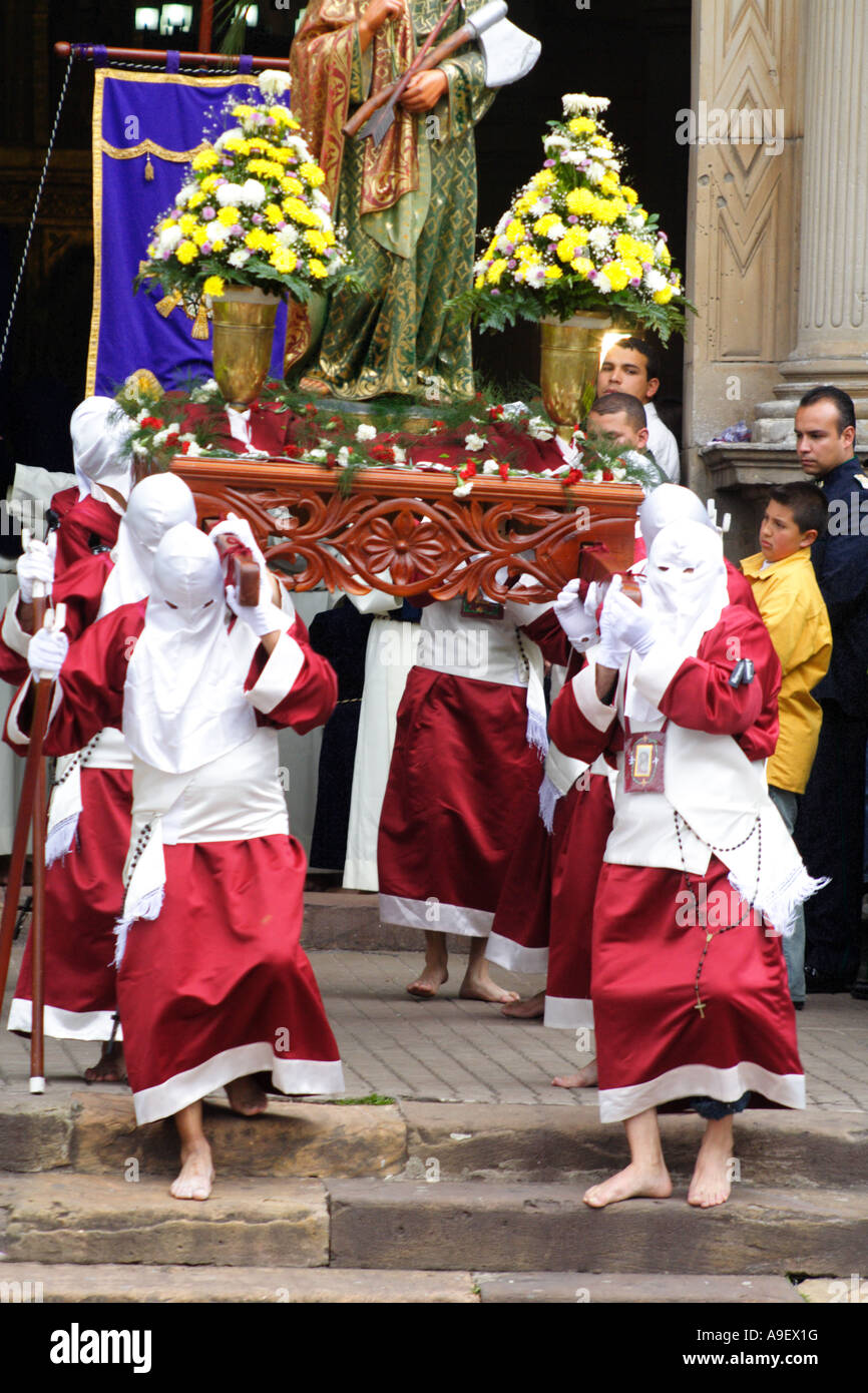 Group of men in penitence costume carrying a traditional religious ...