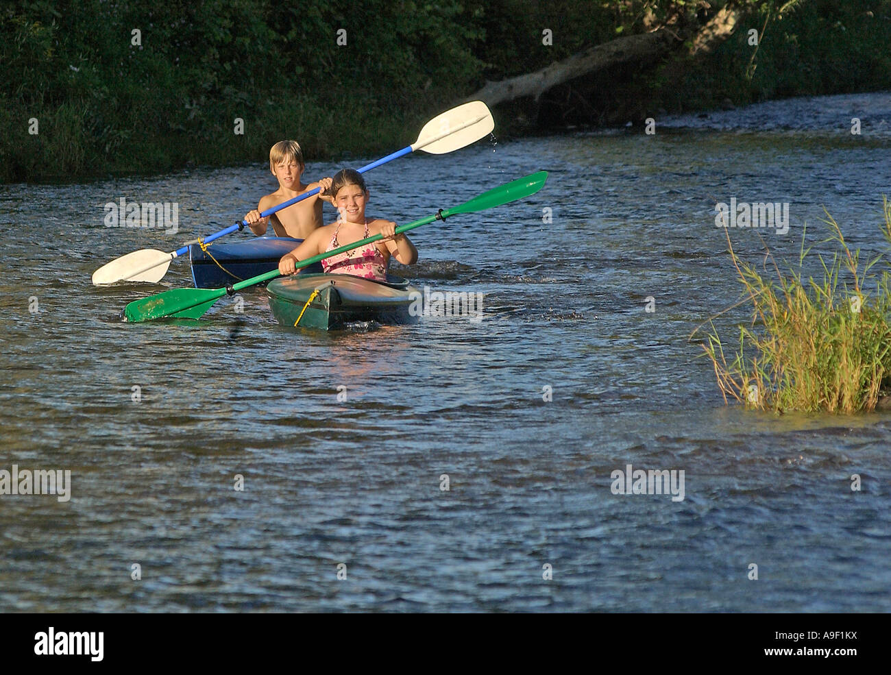kids kayaking in a river Stock Photo - Alamy