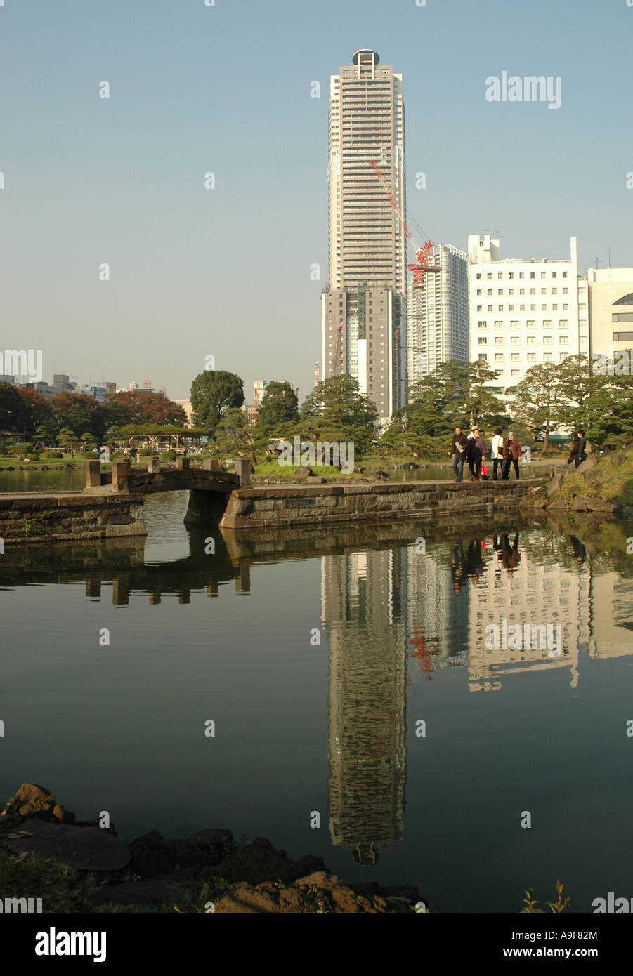 A tokyo skyscraper reflected in a traditional garden pond Stock Photo ...