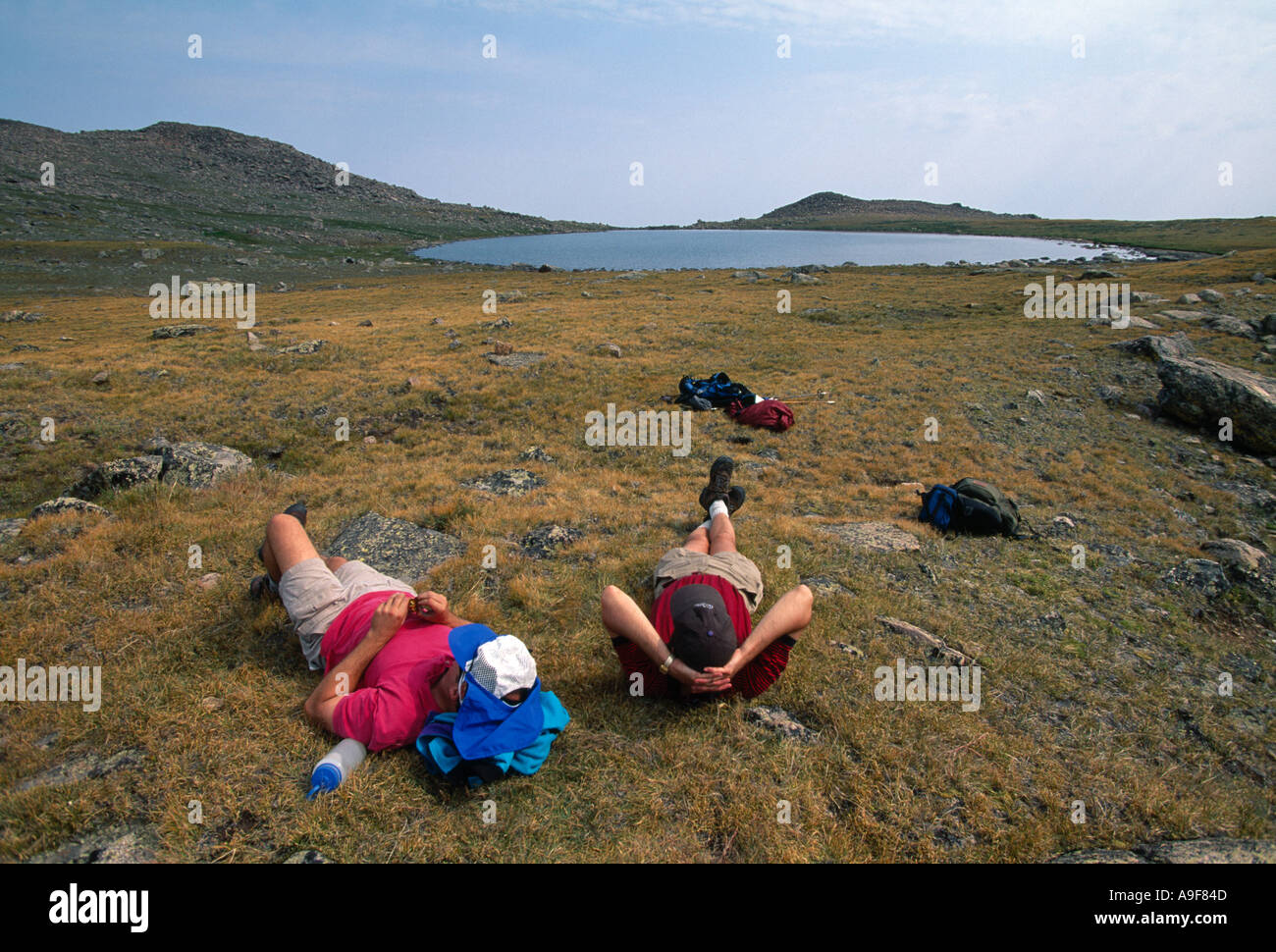 Two hikers reclining on tundra Eagles Nest Wilderness CO Stock Photo ...