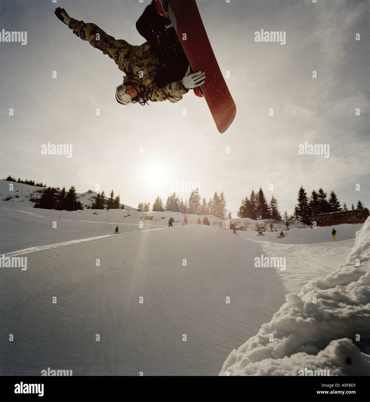 snowboarder on half pipe big air pumping upside down grab Stock Photo ...