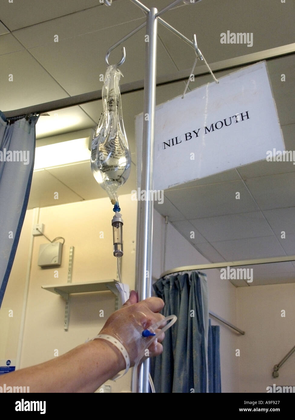 Nil by mouth notice sign close up patient in bed connected to drip feed ...