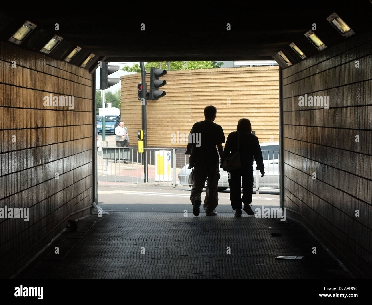 Romford pedestrian subway under railway line couple walking close up ...