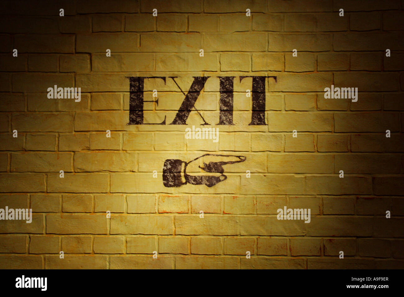 Old style Exit sign painted onto a brick wall Stock Photo - Alamy