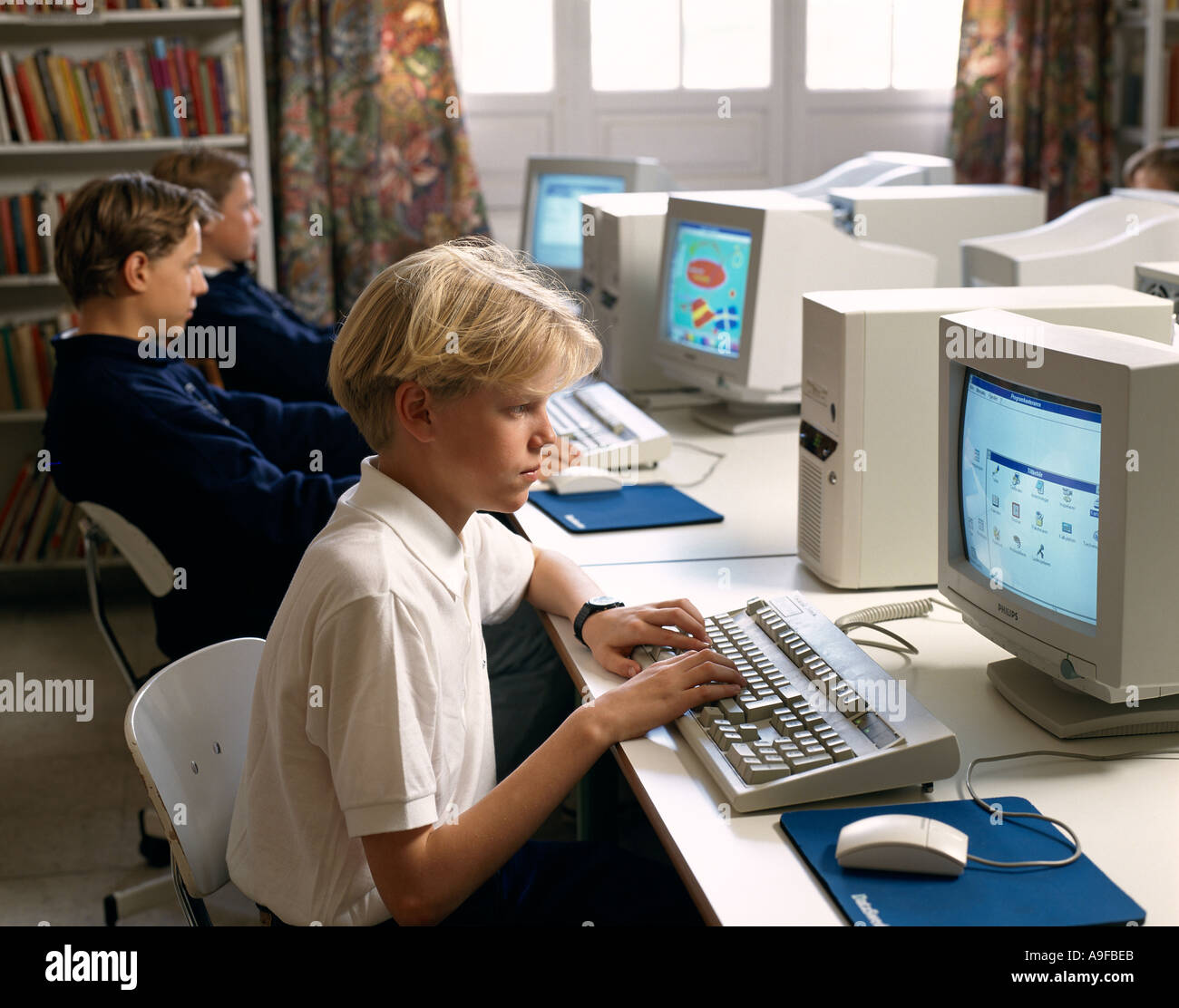 Young teen age students with computers in classroom Stock Photo - Alamy