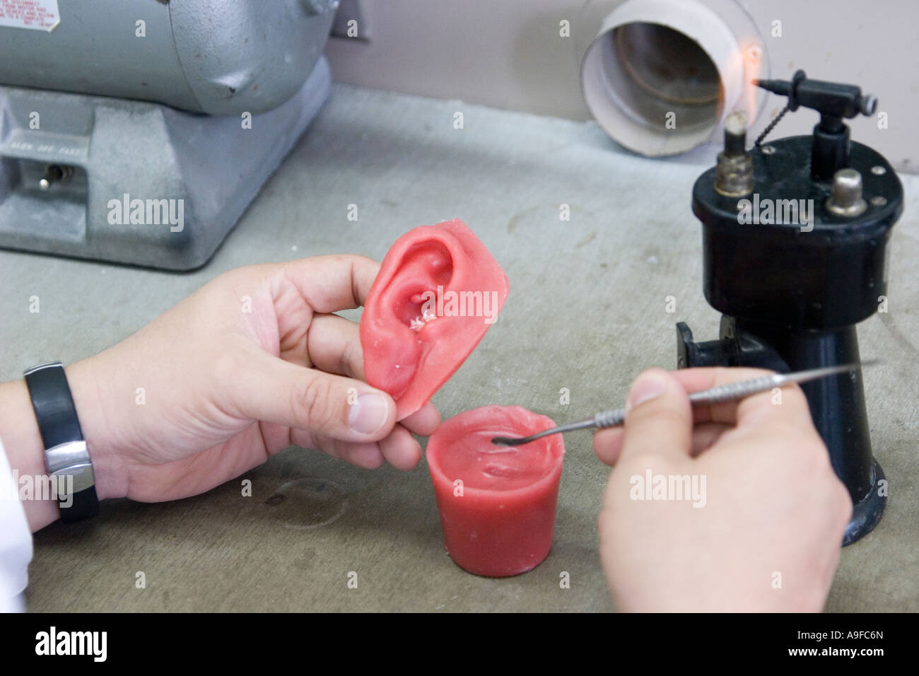 Specialist waxes an ear model for a prosthesis Stock Photo - Alamy
