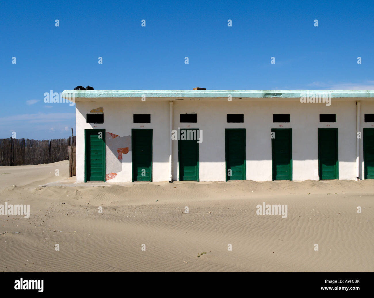row of changing bathing chalets on beach in Italy Stock Photo - Alamy