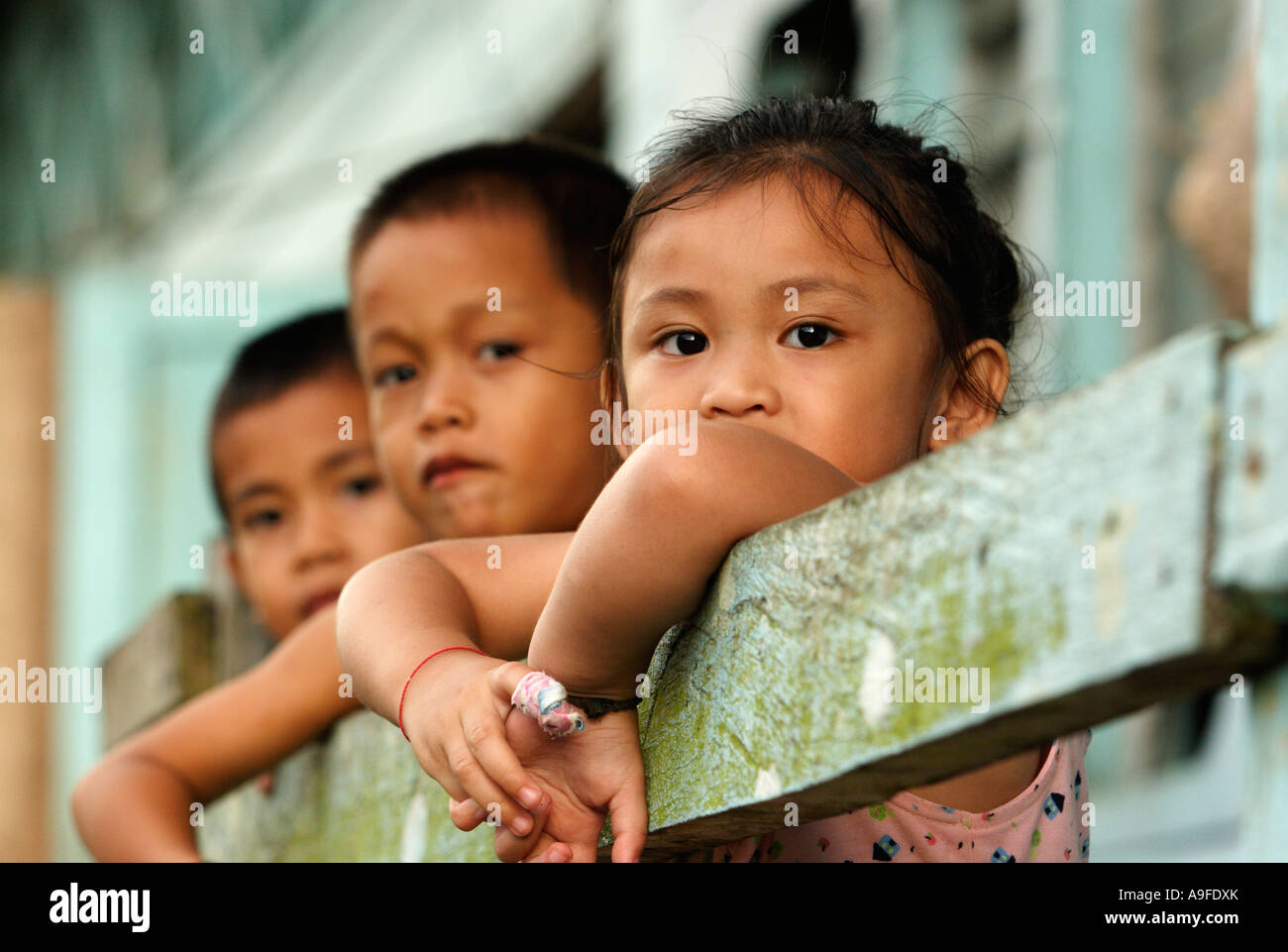 Asia, Borneo, Malaysia, Sarawak, children in front of Iban longhouse ...