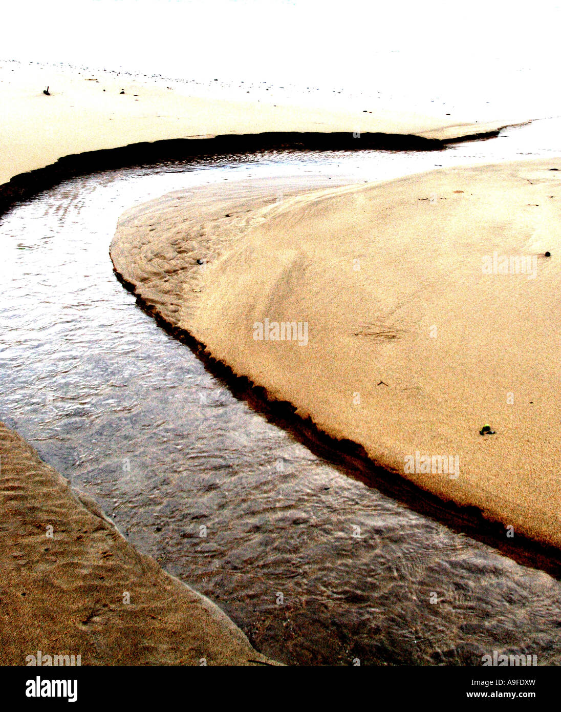 Asia, Malaysia, Borneo, Sarawak, freshwater stream emptying into ocean ...