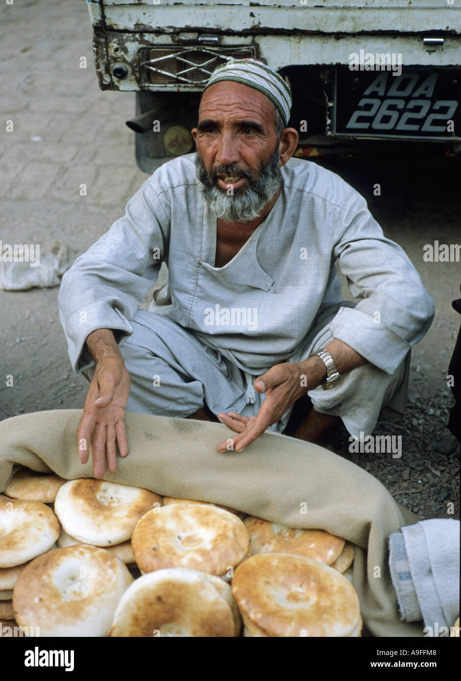 Man selling bread on street in Peshawar North West Frontier region ...