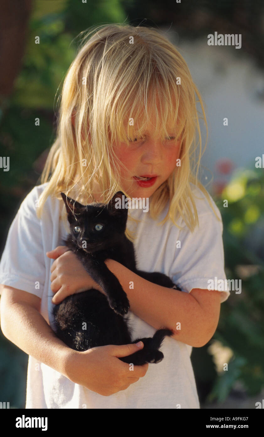 girl holding cat in poor Stock Photo - Alamy