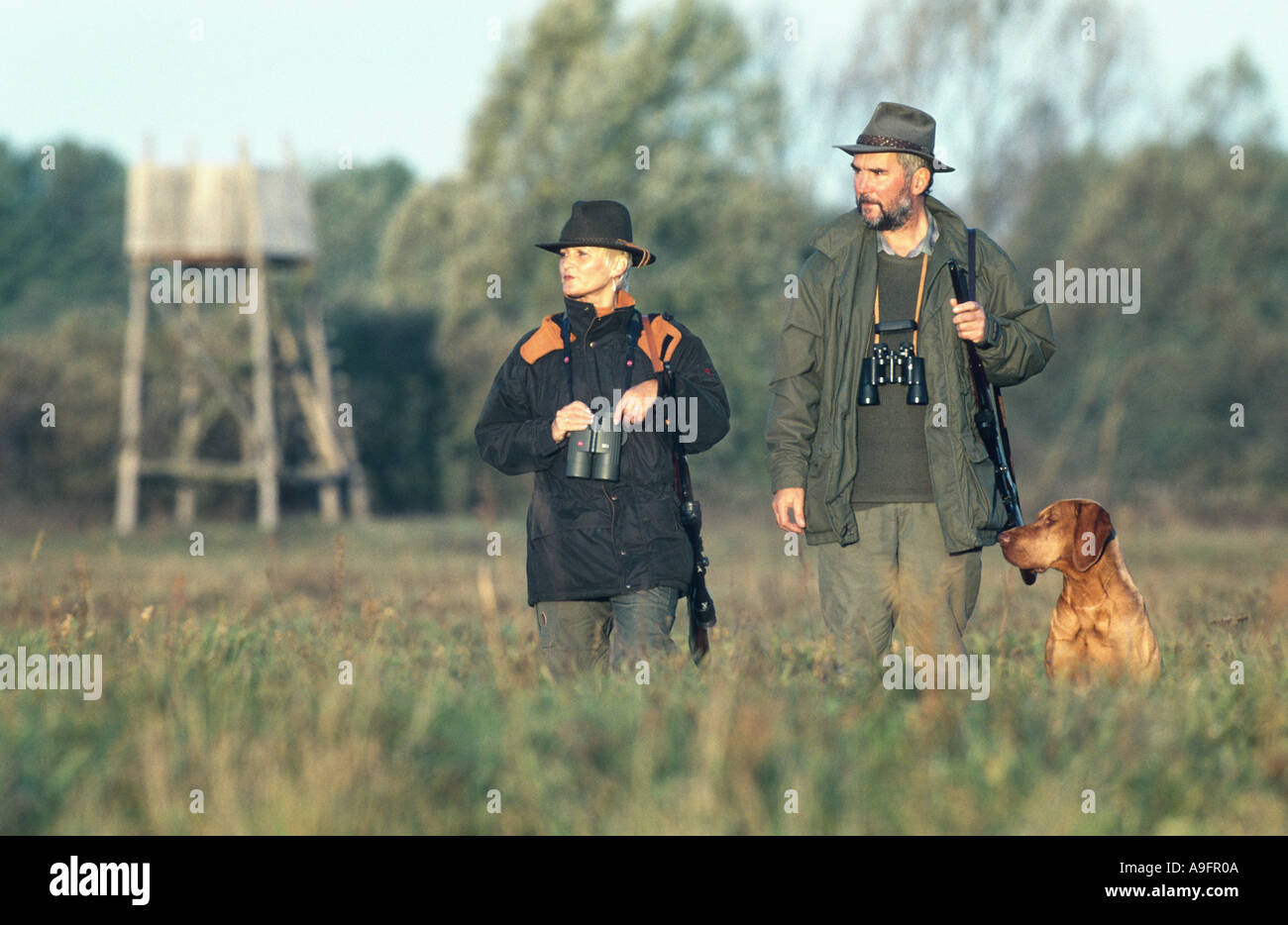 two hunters with hunting dog Stock Photo - Alamy