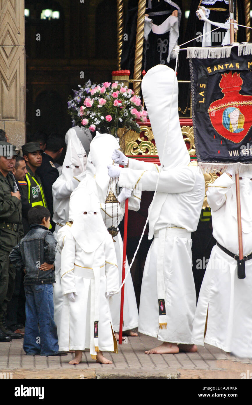 Group of men in penitence costume carrying a traditional religious ...