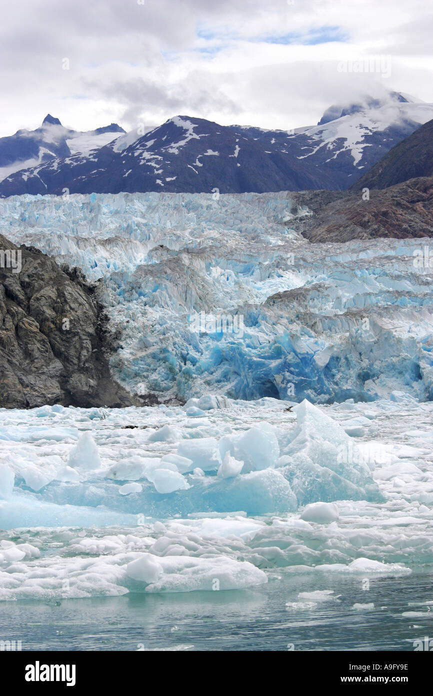 calving glacier, blue ice falling into water, USA, Alaska, Tracy Arms ...