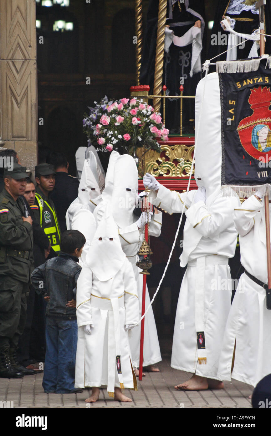 Group of men in penitence costume carrying a traditional religious ...