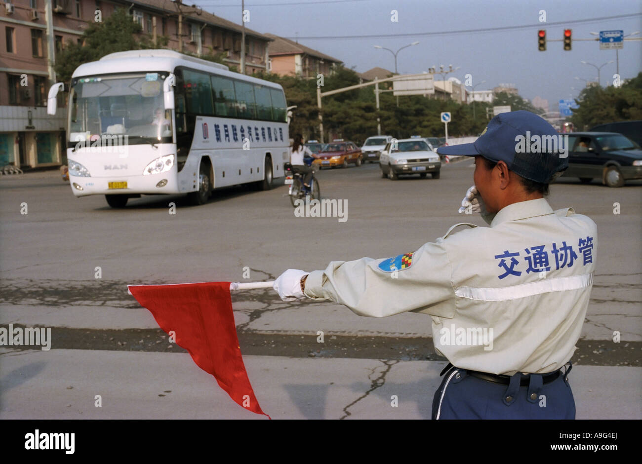 CHN China Beijing Uniformed woman controlling the traffic at a crossing ...