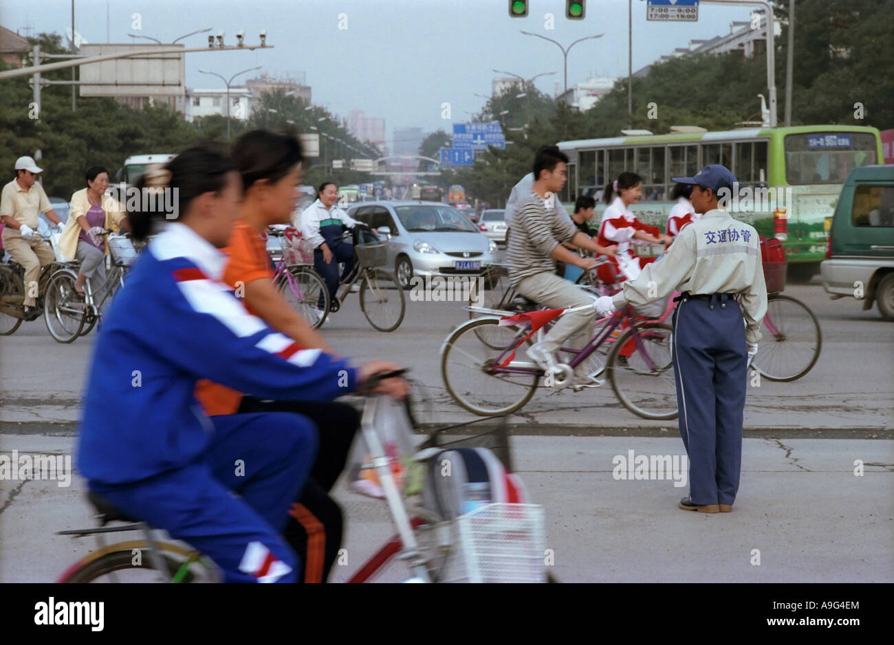 CHN China Beijing Uniformed woman controlling the traffic at a crossing ...