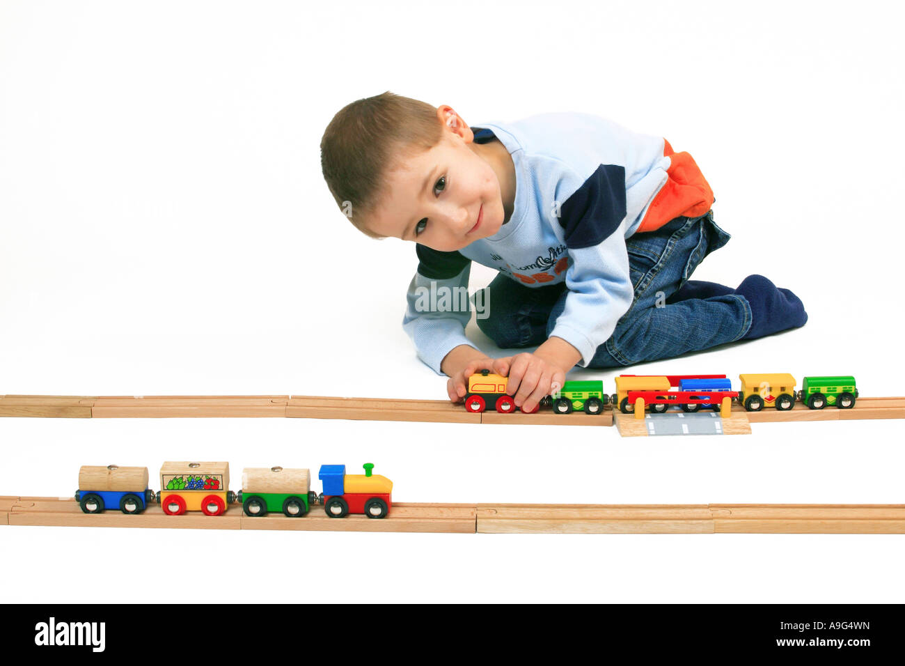 Boy playing with toy trains Cut Out Stock Images & Pictures - Alamy