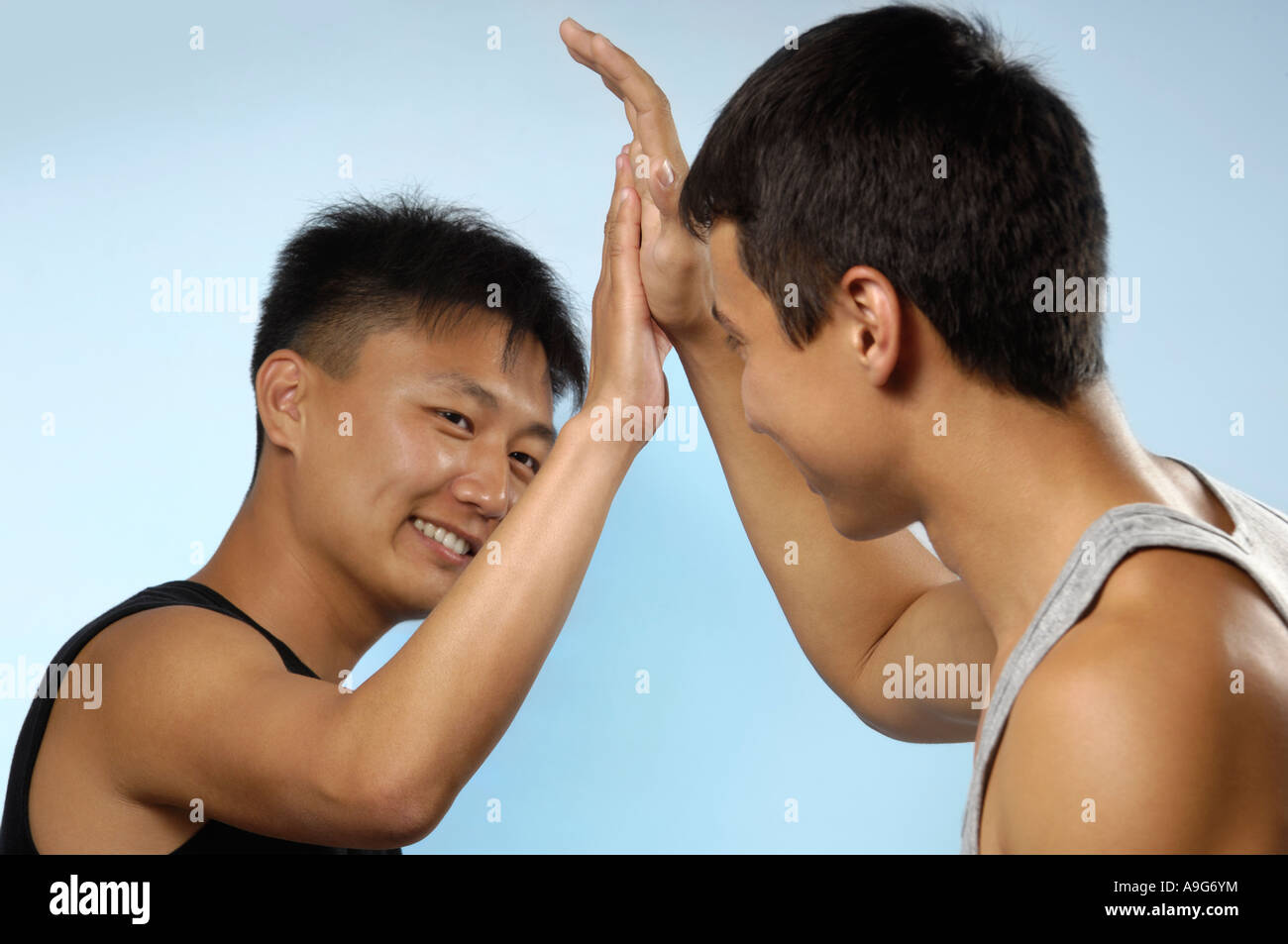 Two young Korean men greeting Clapping each other hands Teens Stock ...