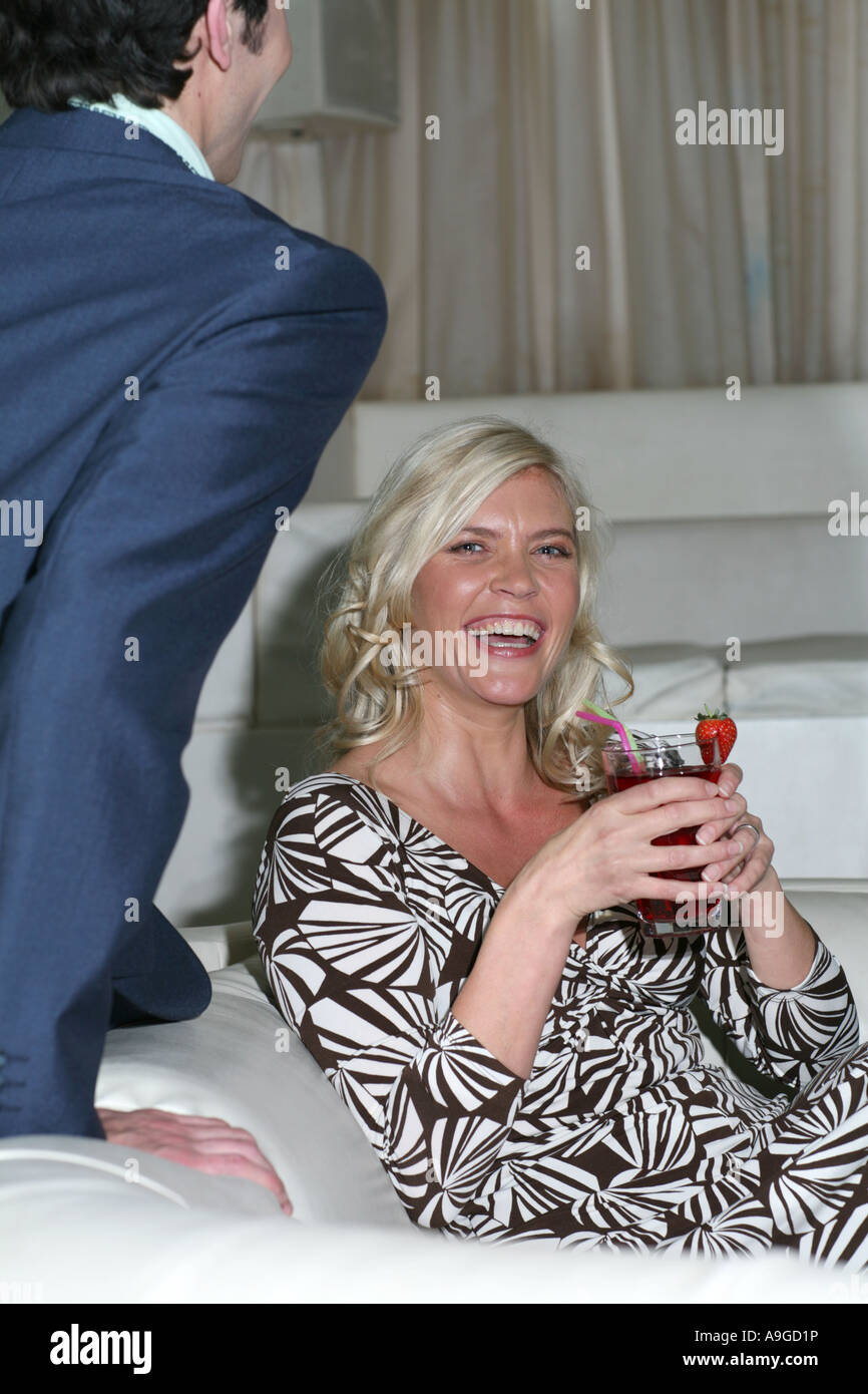 couple socializing over sofa Stock Photo - Alamy