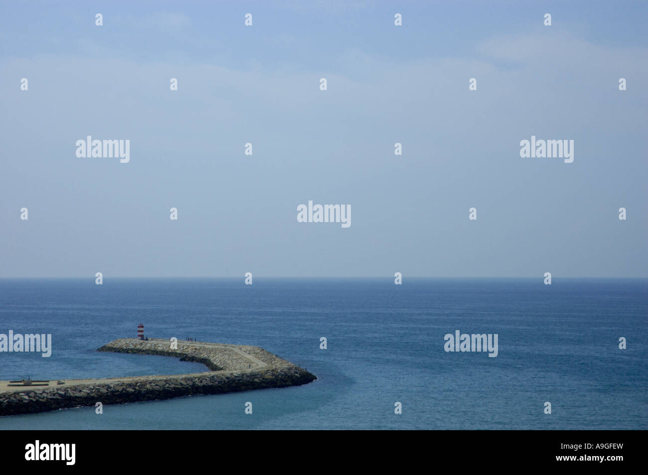 Harbour wall jetting out into the sea Stock Photo - Alamy