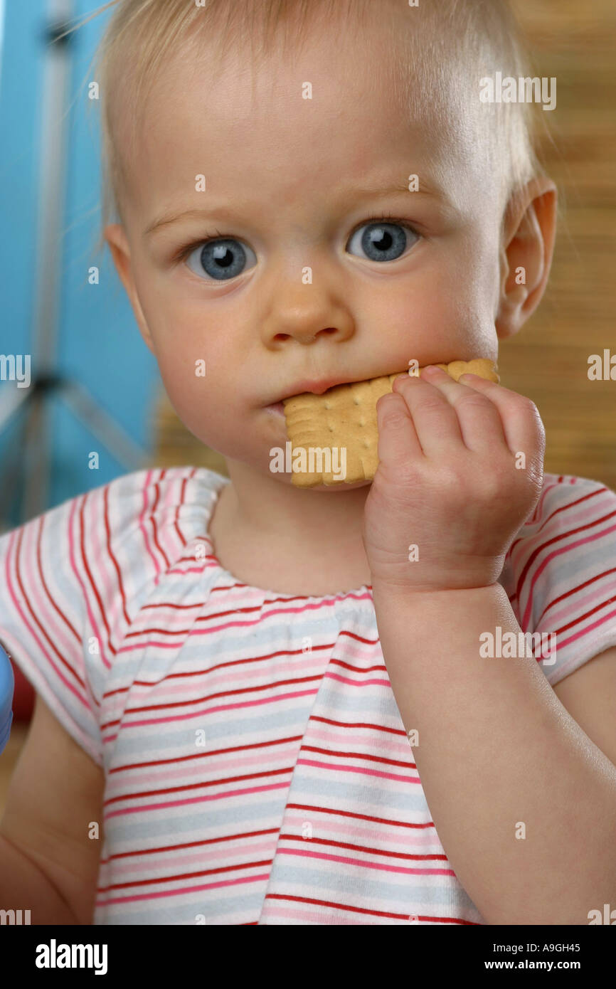 blond girl with biscuit Stock Photo - Alamy