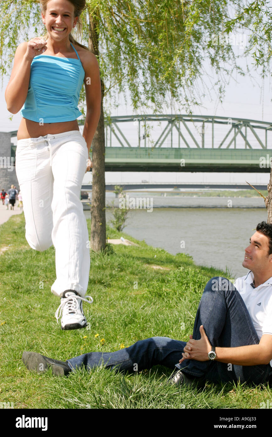 woman jumping over man, at a river shore Stock Photo - Alamy