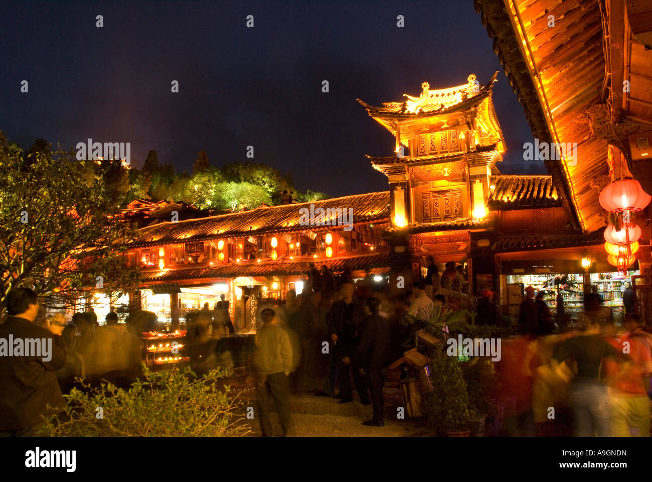Lijiang Old Town night time activity around the stone bridge in central ...