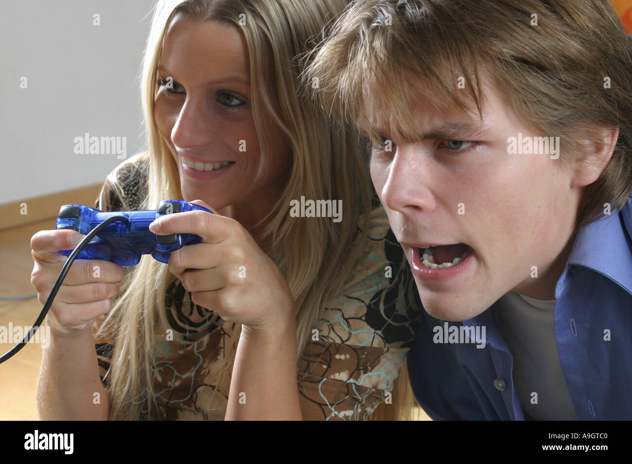 couple playing with play station, holding playstation-controller Stock ...