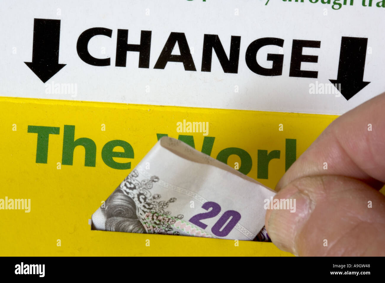 Change the world collecting box with person putting in twenty pound ...