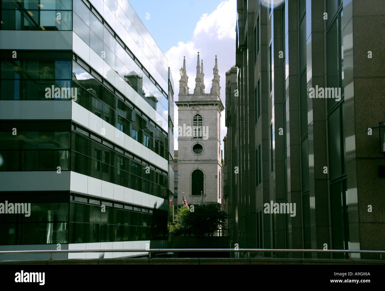 a church seen in the distance between two office block st pauls area of ...