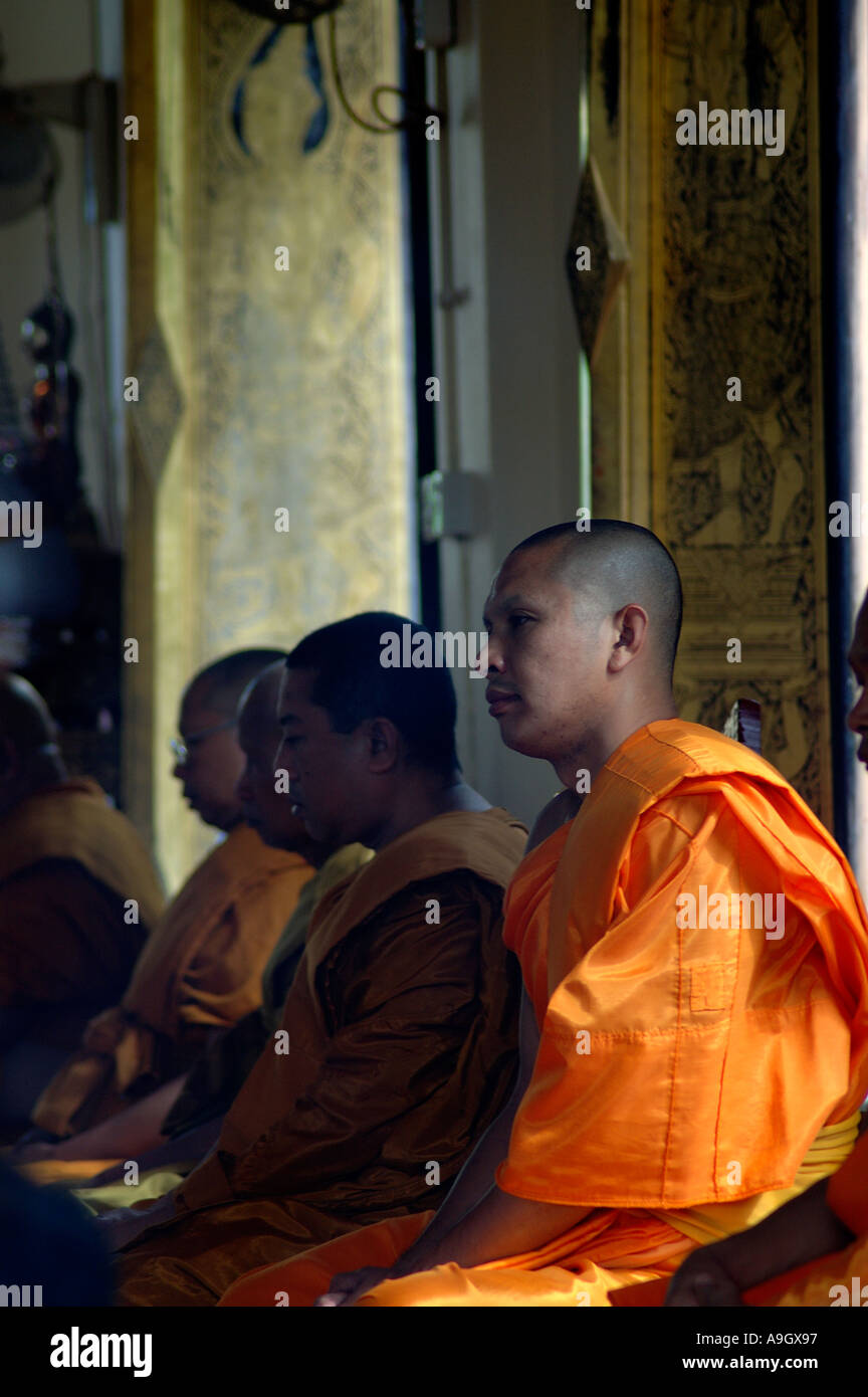 Buddhist monks holding prayers Stock Photo - Alamy