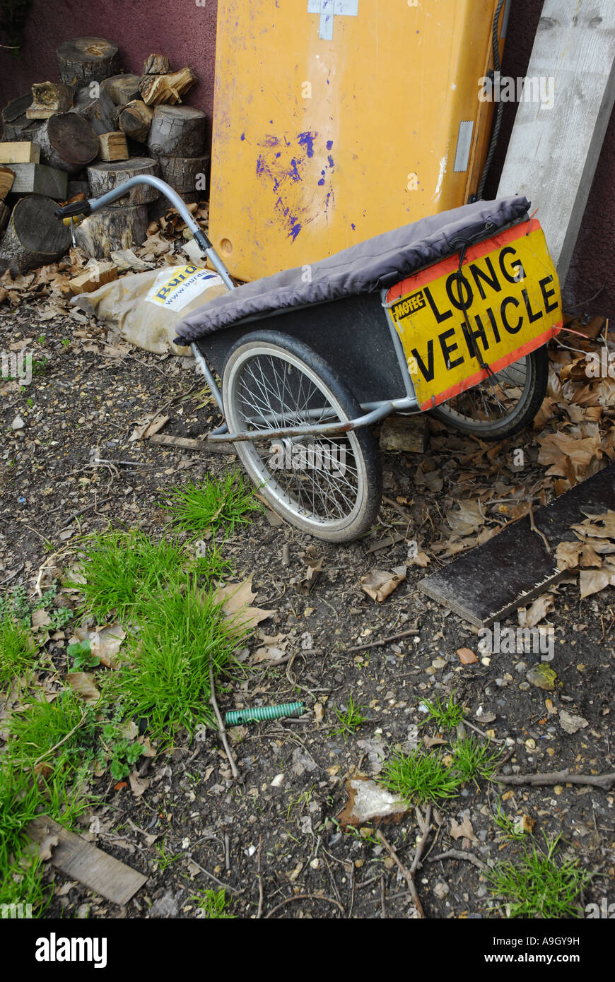Wheel barrow with 'Long Vehicle' sign on it Stock Photo - Alamy