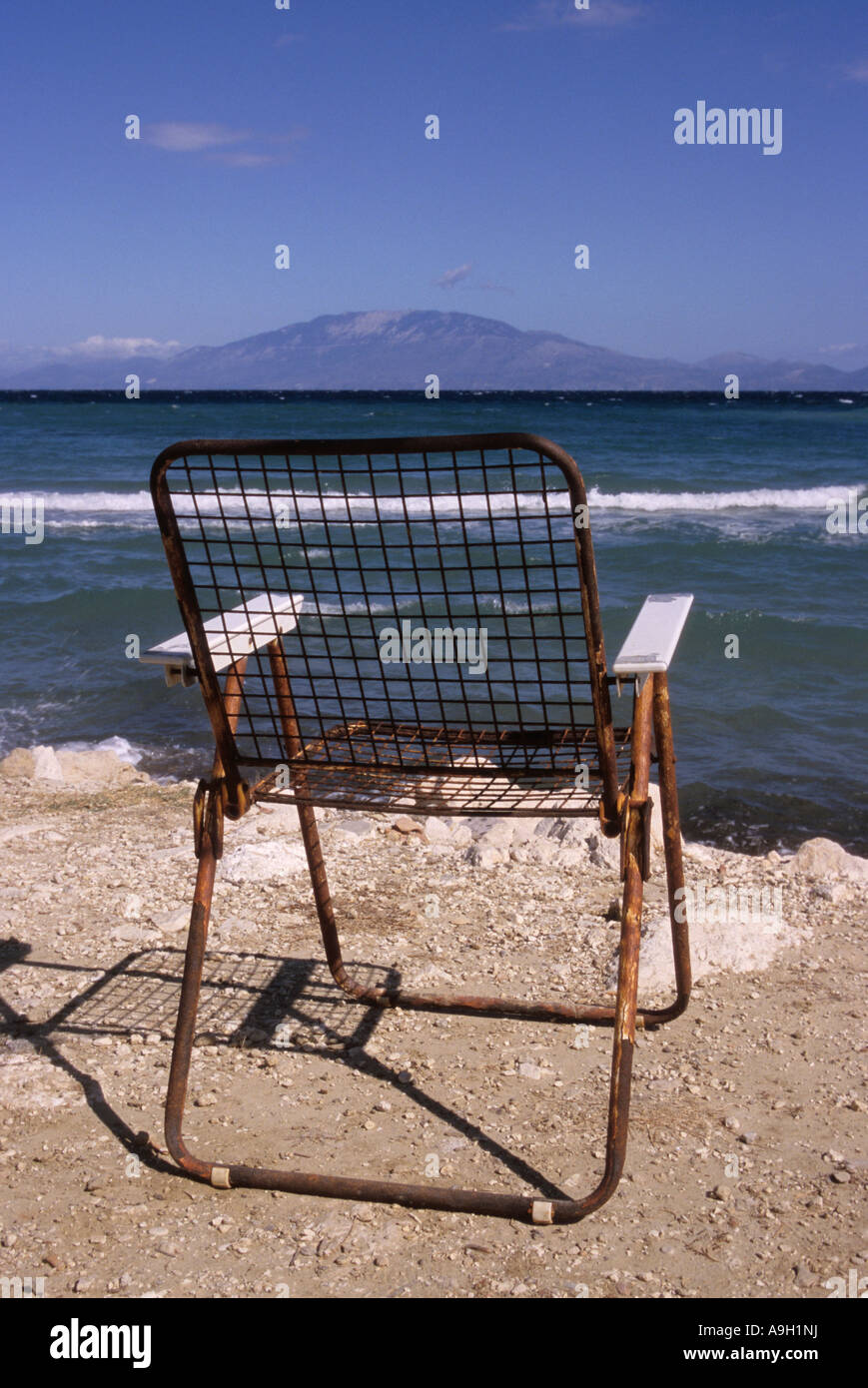 rusted chair in front of the sea Greece Stock Photo - Alamy
