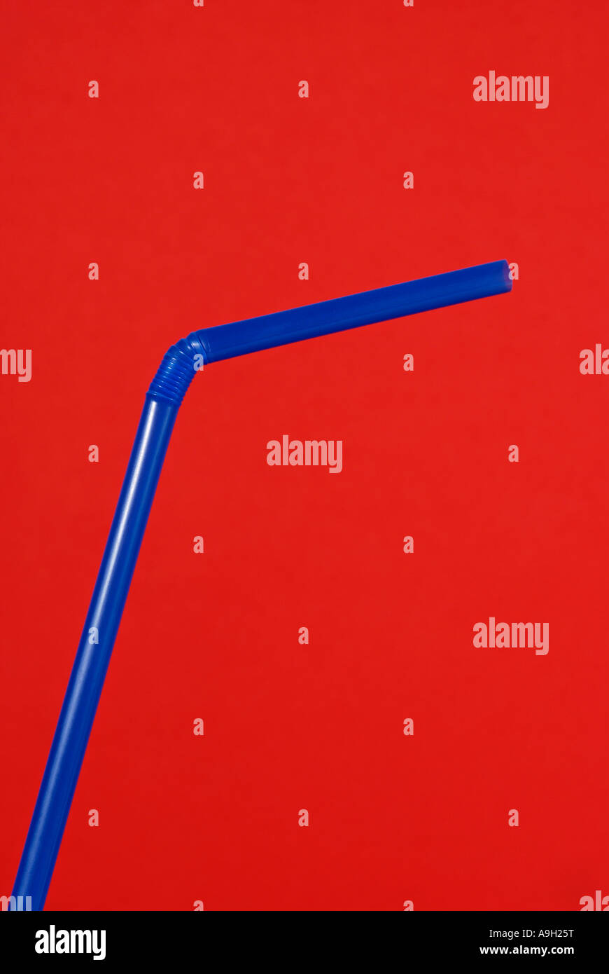 blue flexible straw on red background Stock Photo - Alamy