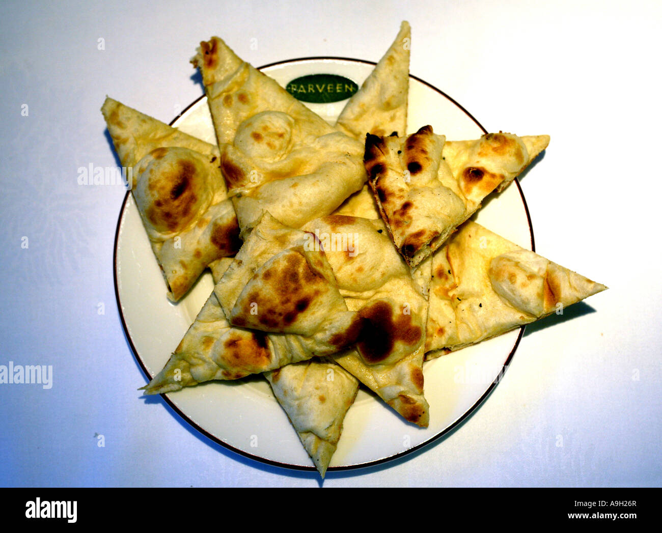 Nan bread on plate in Indian restaurant London 2007 Stock Photo - Alamy