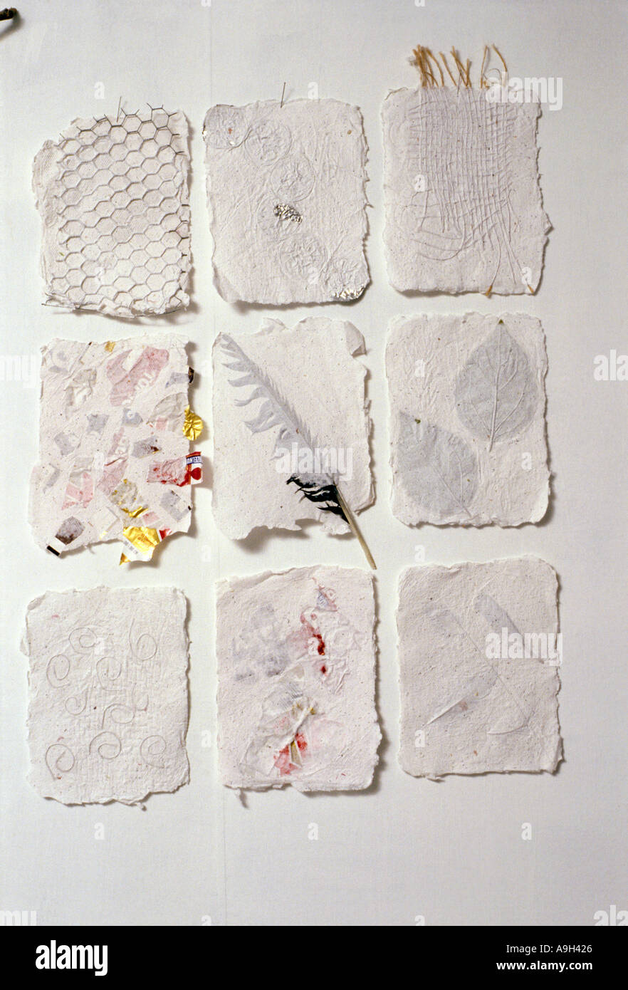 Sheets of hand made white paper with wire, feathers, leaves and ...