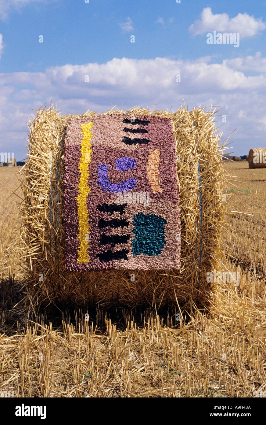 Yellow stripe, a tufted rag rug draped over a round straw bale. Rag rug ...