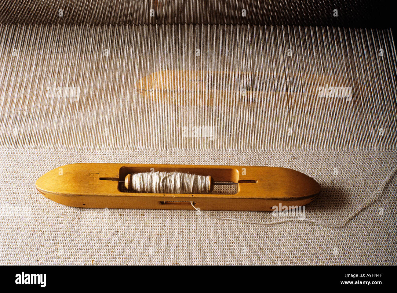 A bobbin filled with linen placed on the loom Stock Photo - Alamy