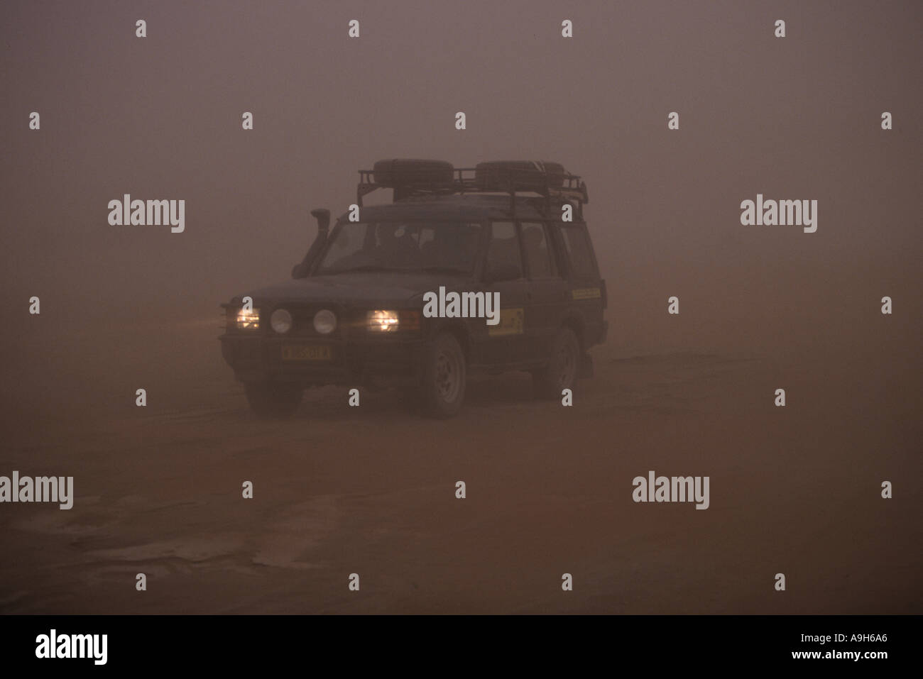 Dust Storms Four wheel drive car in sand storm Sossus Vlei Namib Desert ...