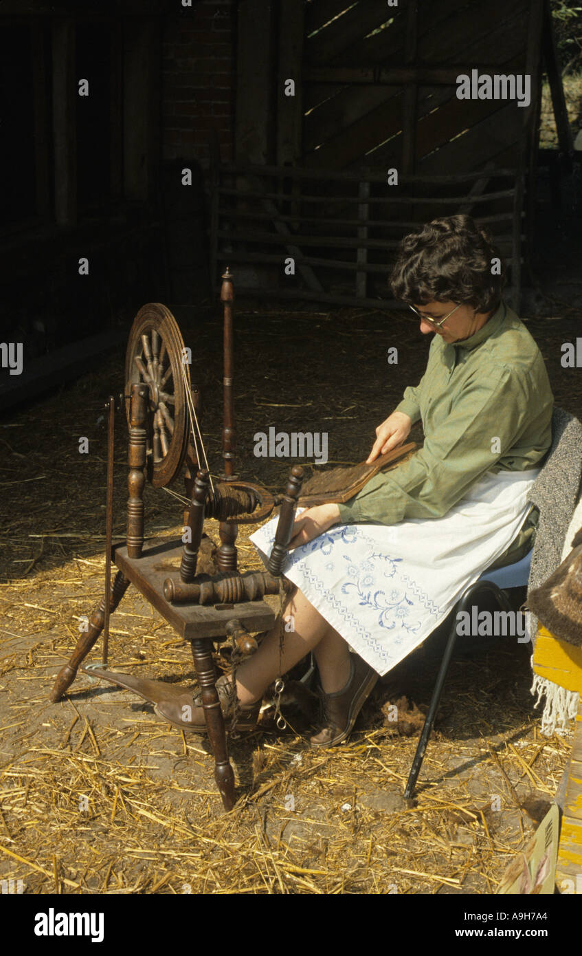 Country Skills Spinner at work with spinning wheel on a Shropshire farm ...