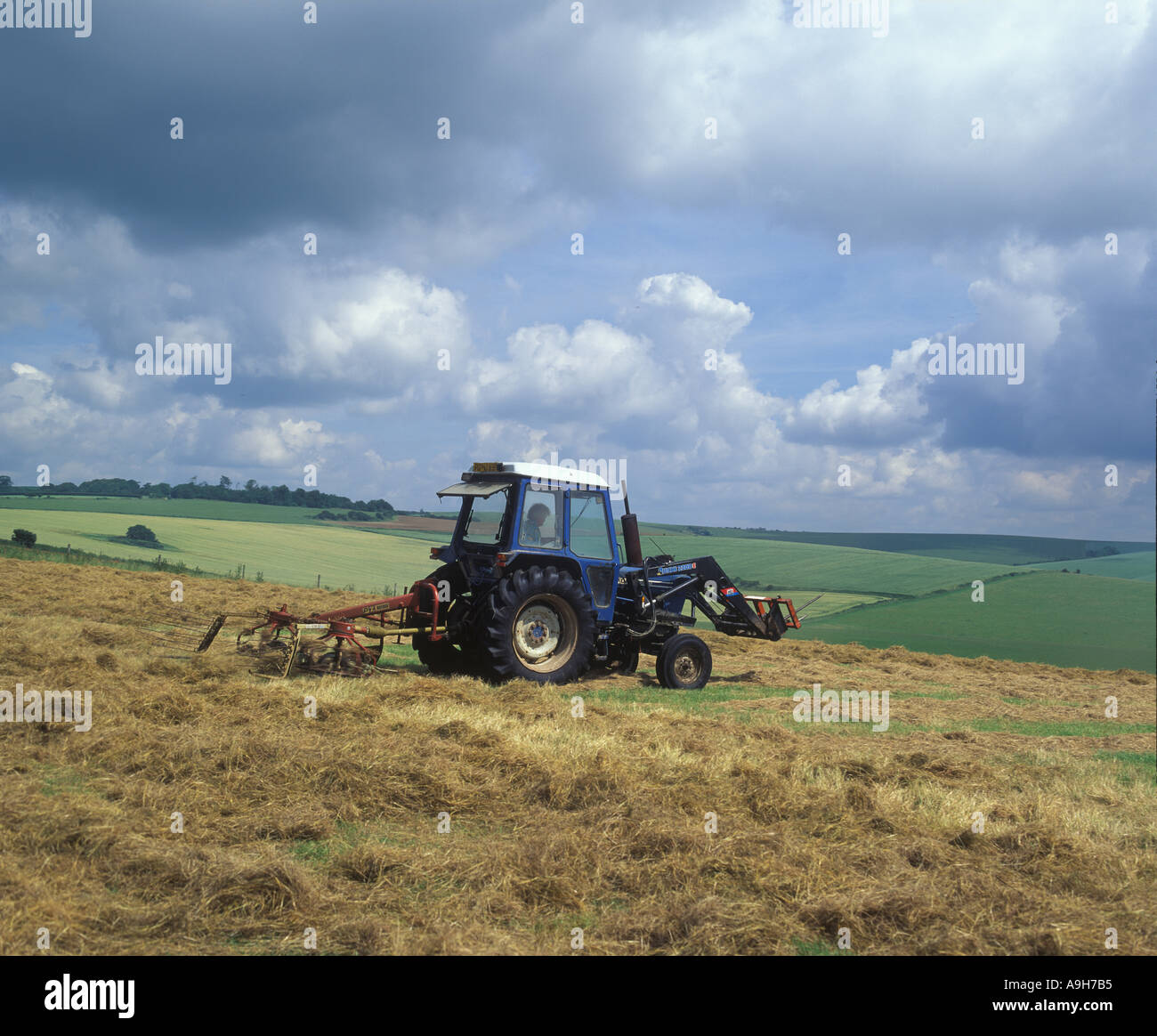 Farming Hay Turning hay West Sussex July Stock Photo - Alamy